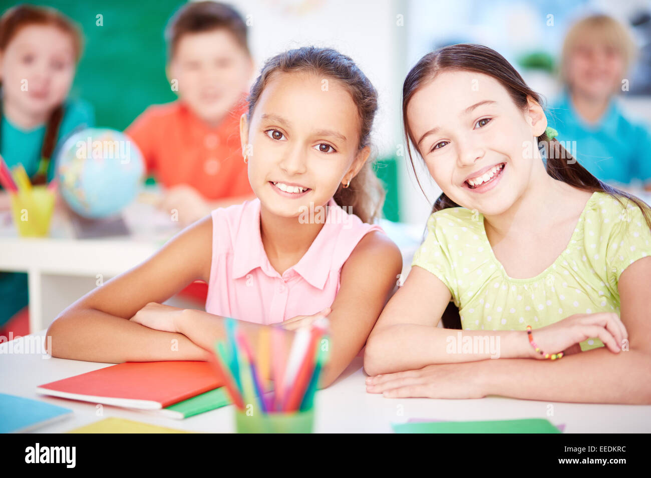 Two smiling schoolgirls in classroom hi-res stock photography and ...