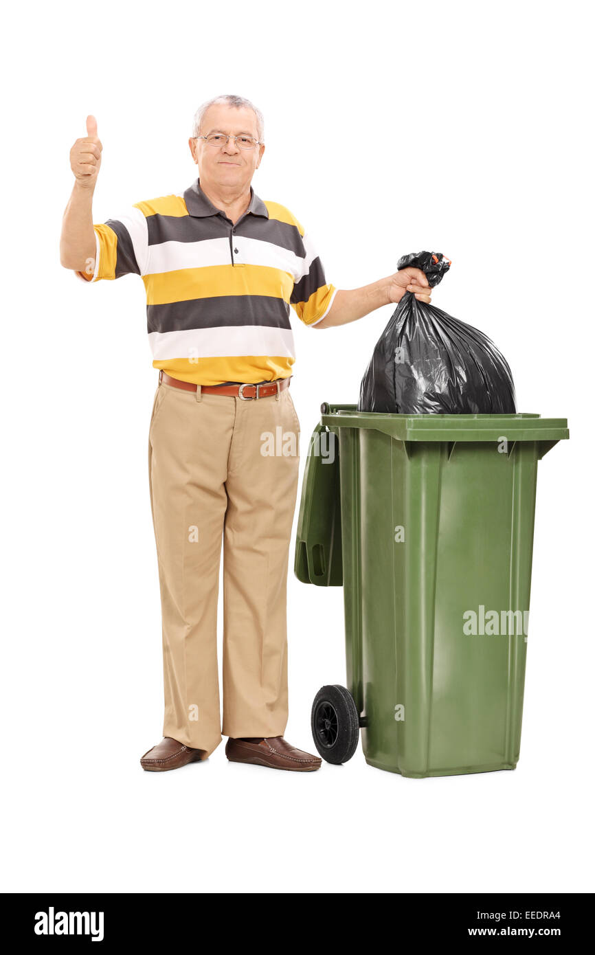 Full length portrait of a senior giving a thumb up by a trash can ...