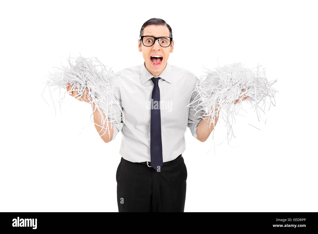 Terrified man holding a bunch of shredded paper isolated on white ...