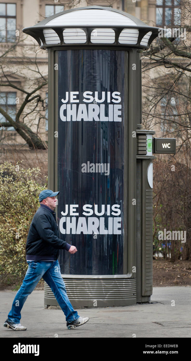 Man went around an advertising column, where is black posters with ...