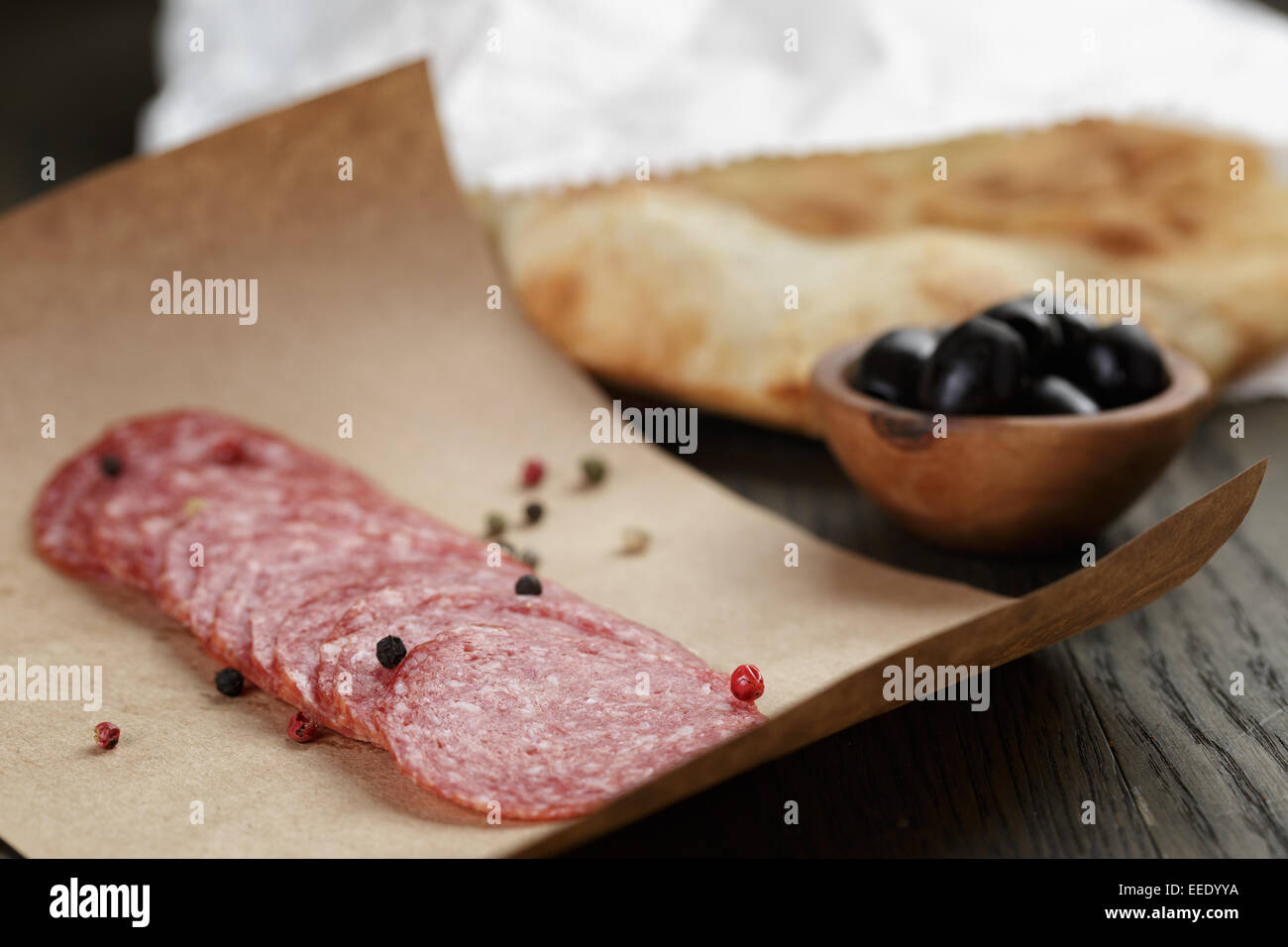 dried salami sausage on paper ready for sandwich, rustic style Stock ...