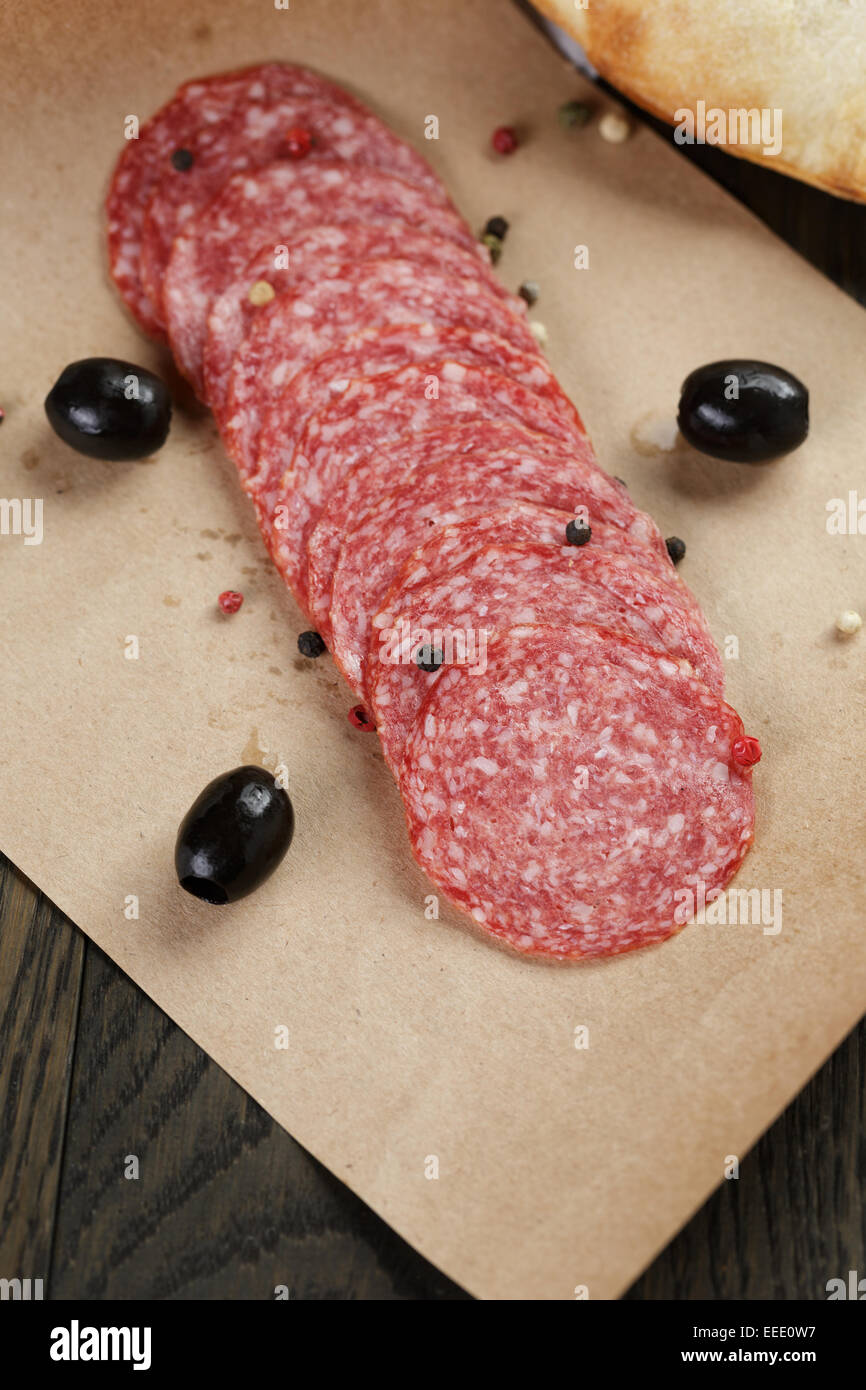 dried salami sausage on paper ready for sandwich, rustic style Stock ...