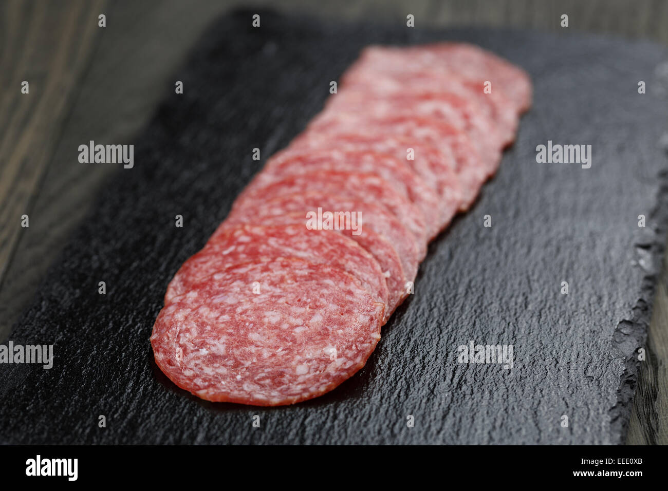 Salami slices slate board, rustic style food Stock Photo - Alamy