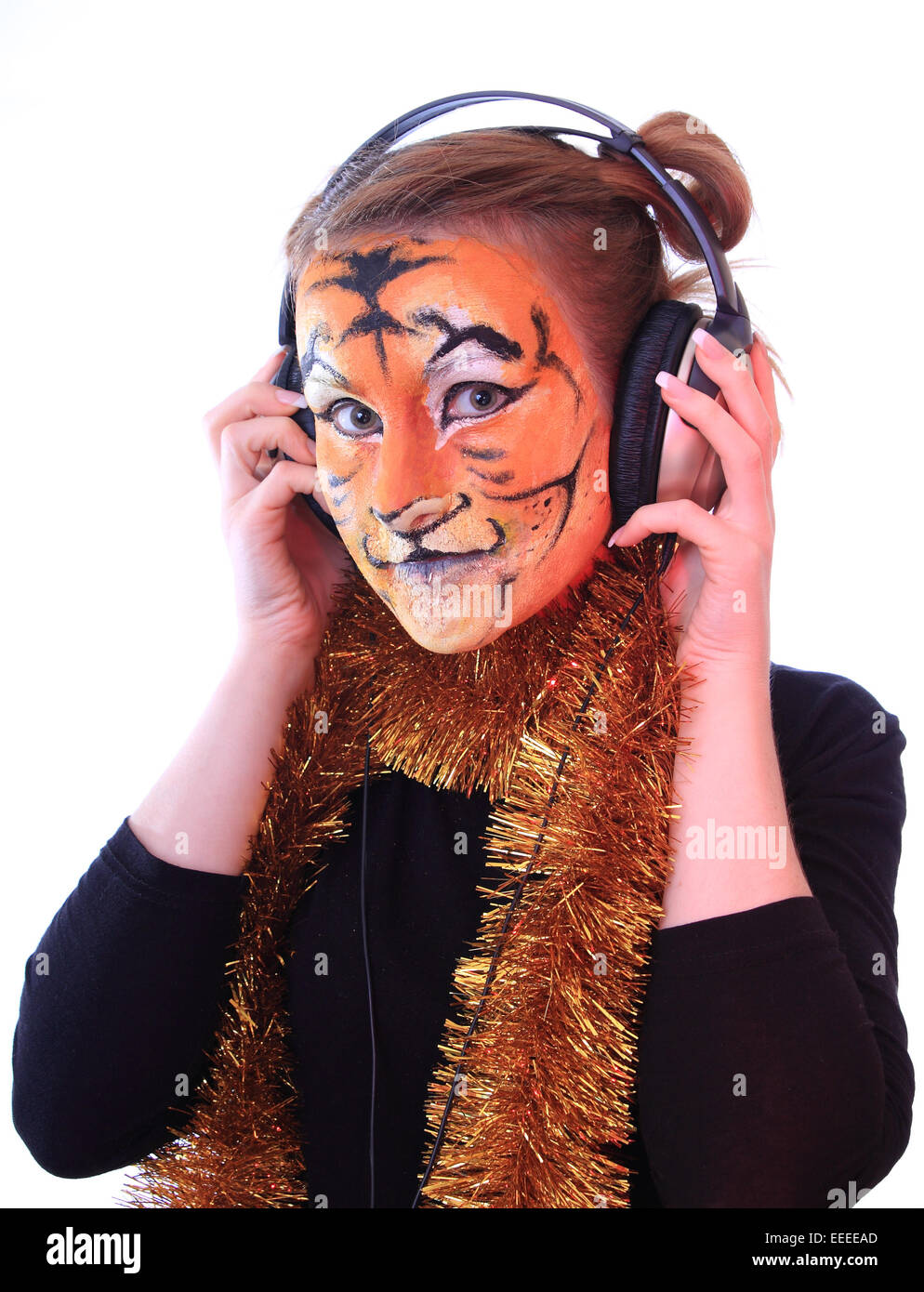 Girl a tiger in headsets listens music Stock Photo - Alamy