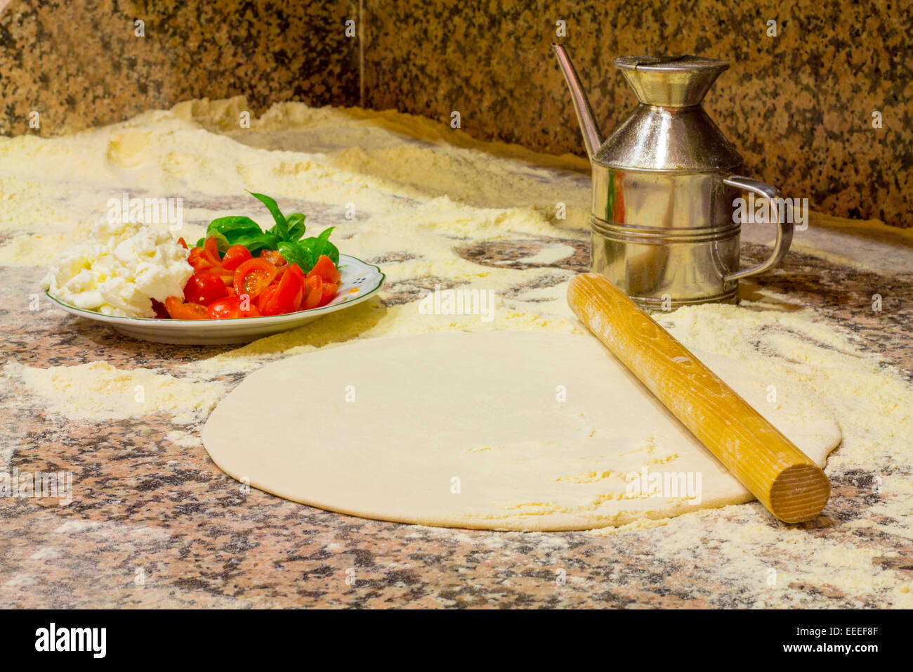 Make a typical italian food, dough, cheese, tomato, basil, flour Stock ...