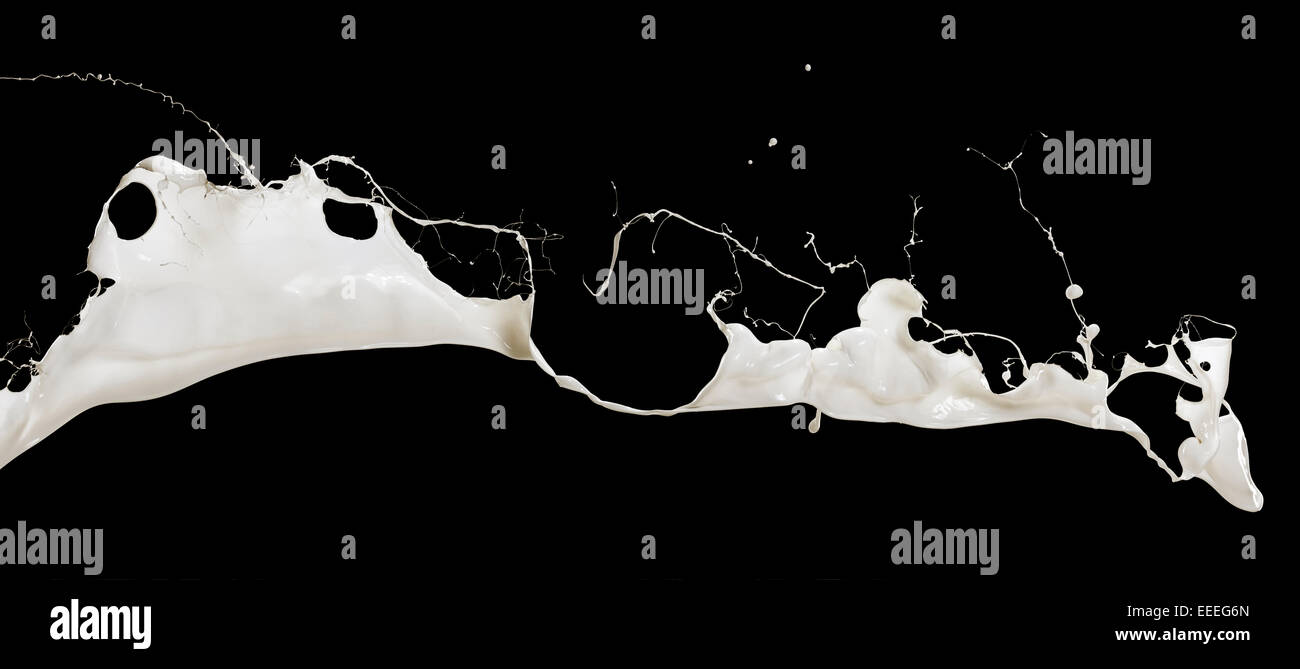 flying splashing milk isolated on black background Stock Photo - Alamy