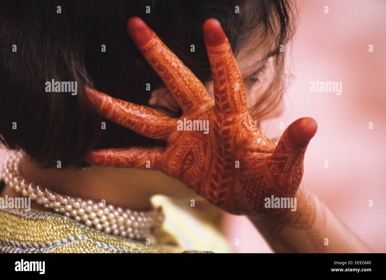 A Moroccan woman has intricate henna design drawn on her hands for a ...
