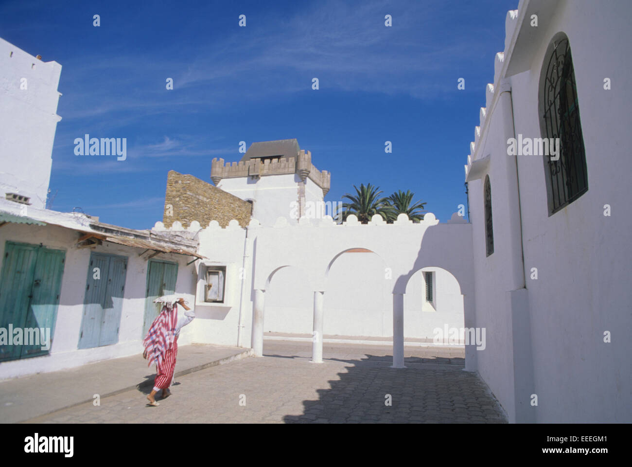 A women in traditional Rif Mountain berber dress walks through the ...