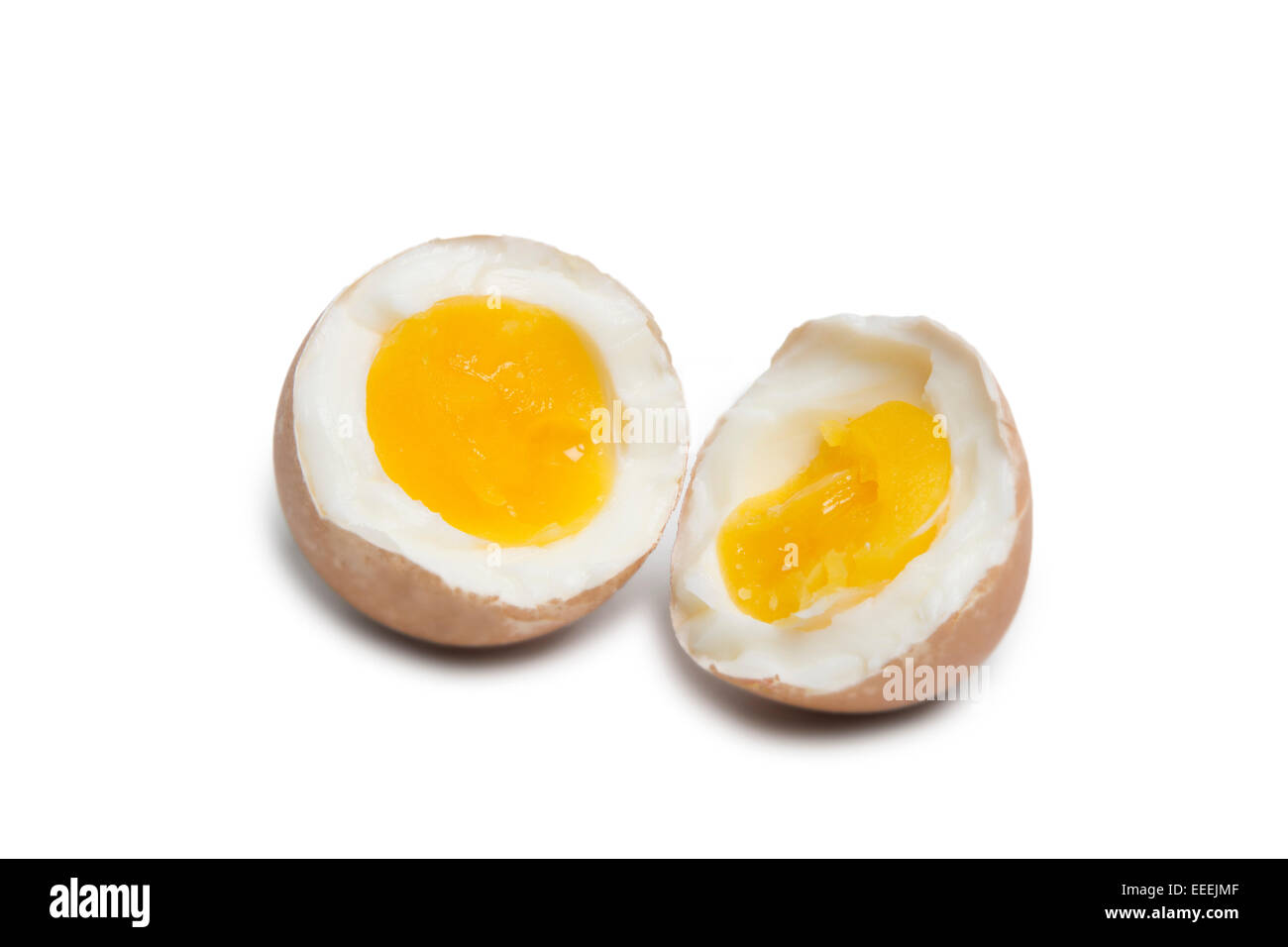 A Boiled egg in brown shell splitted in two halfs isolated on white ...