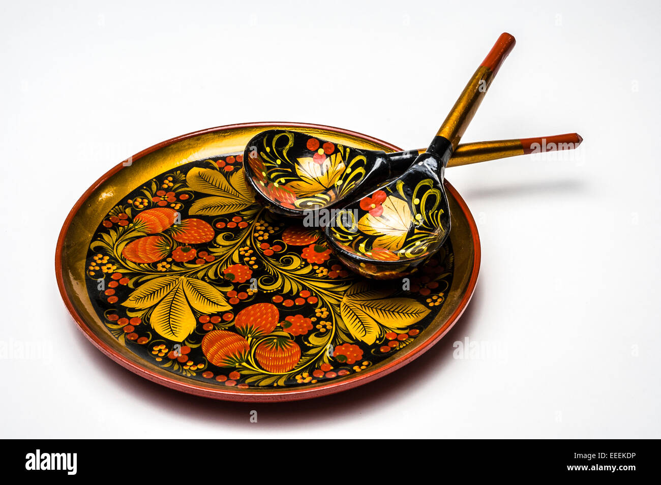russian art khokhloma plate and spoons isolated on a white background ...