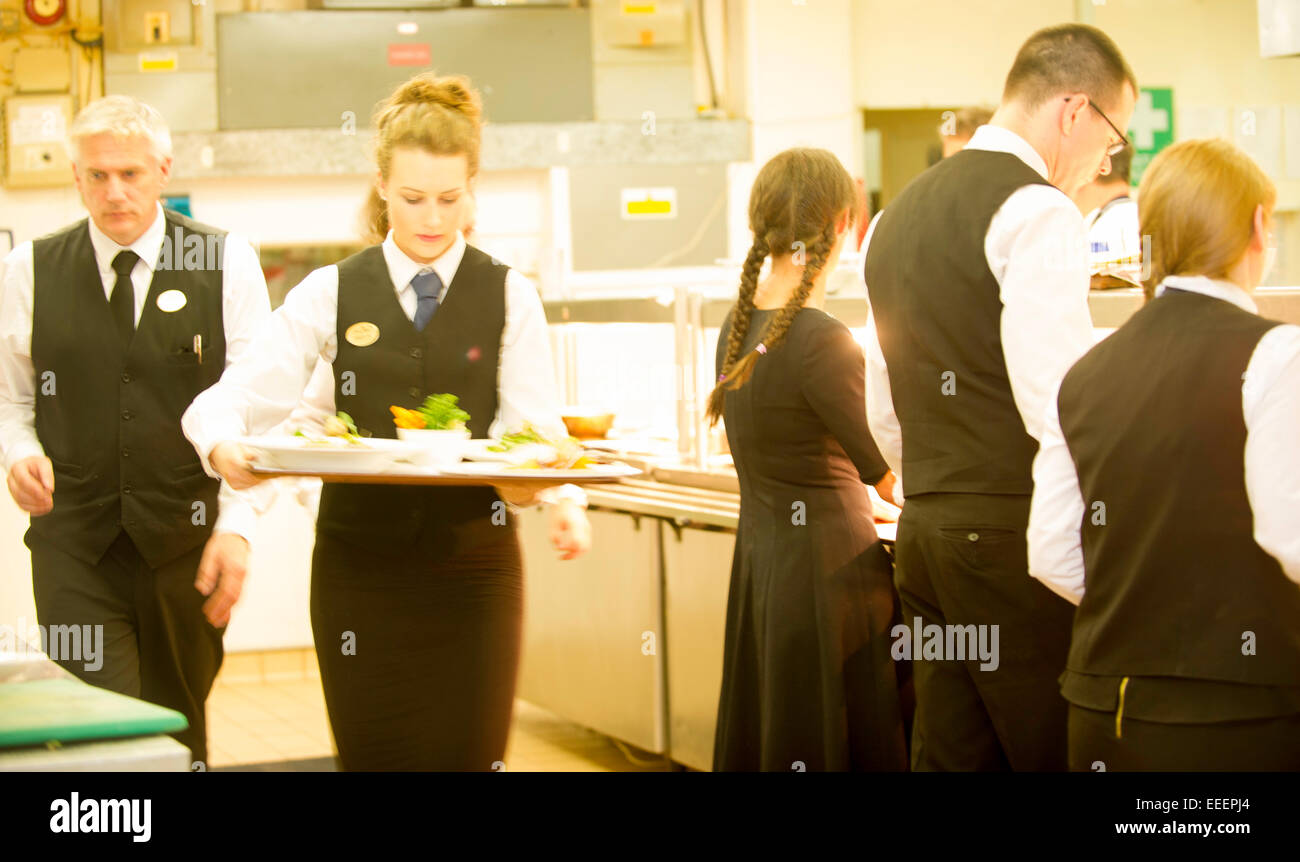 Chefs and kitchen staff working in a busy kitchen Stock Photo - Alamy