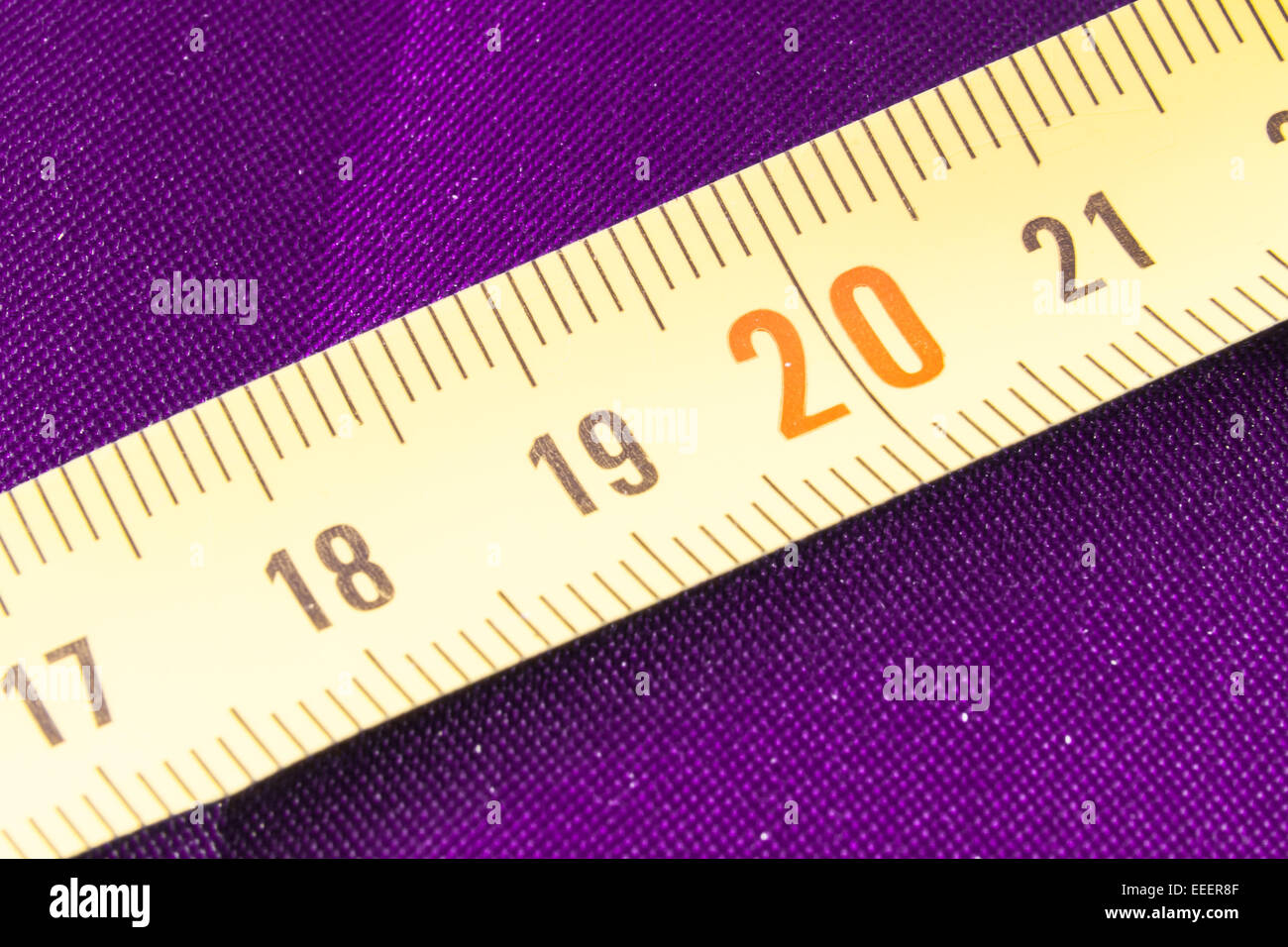 Twenty red centimeter. Particular of a rolled meter Stock Photo - Alamy