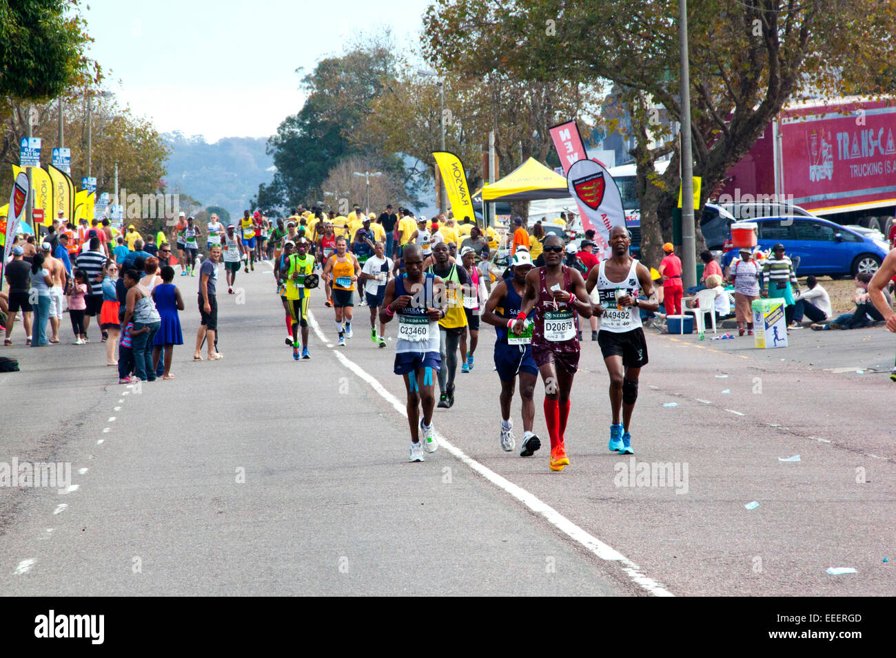 Spectators and Many runners competing in the long distance Comrades ...