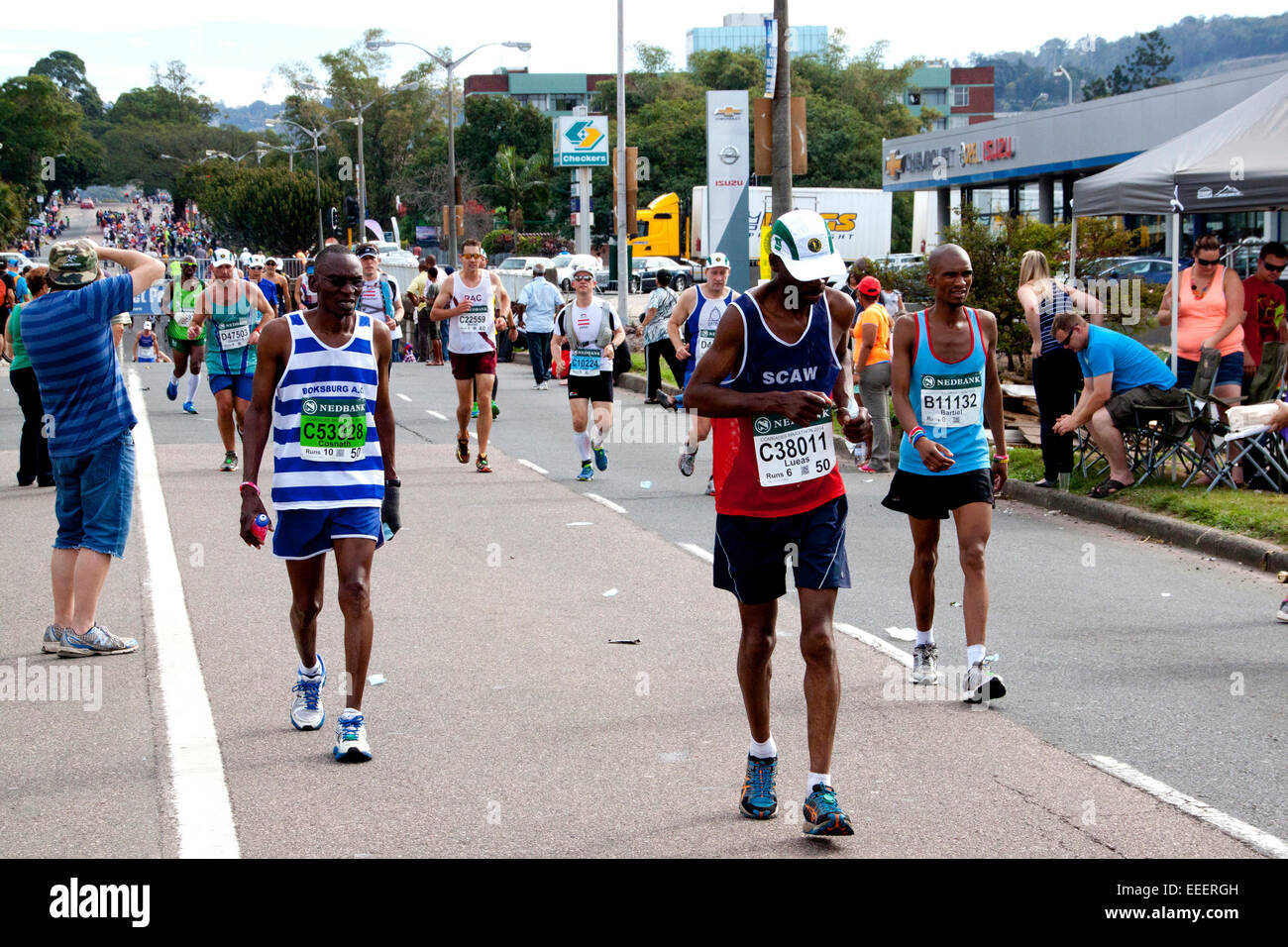 Spectators and Many runners competing in the long distance Comrades ...