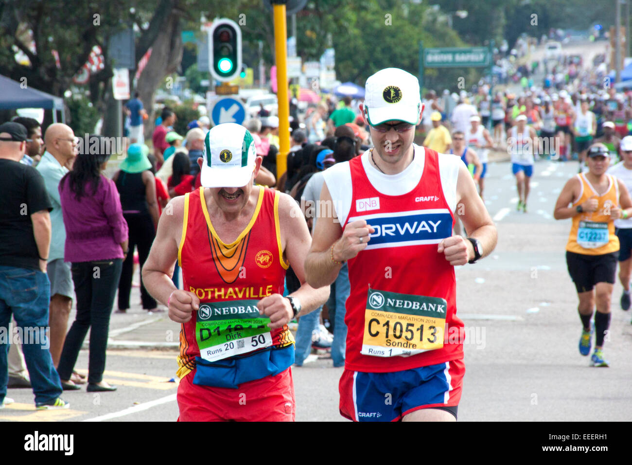 Spectators and Many runners competing in the long distance Comrades ...