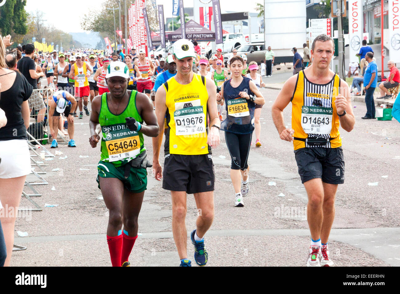 Spectators and Many runners competing in the long distance Comrades ...