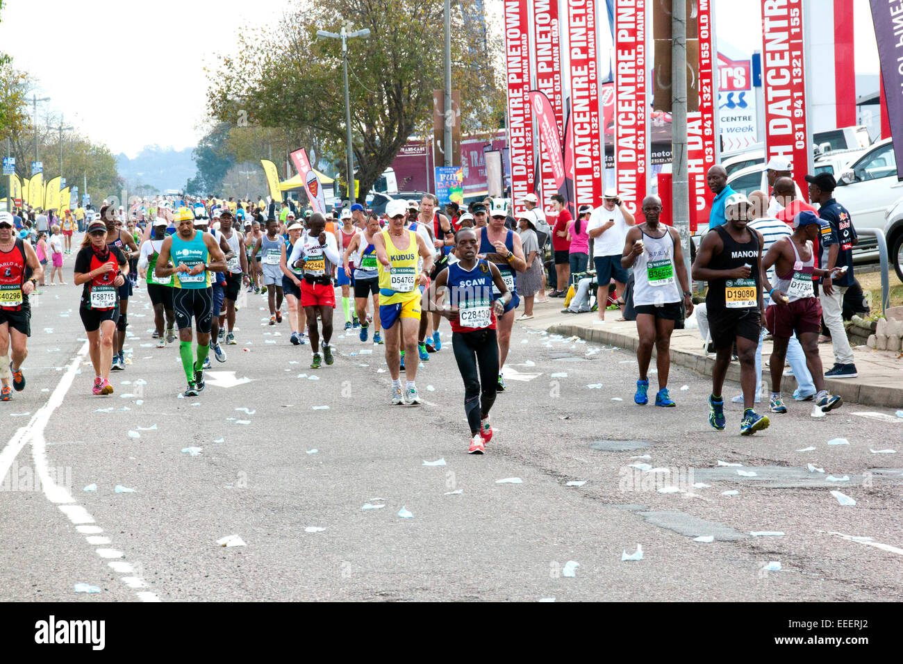 Spectators and Many runners competing in the long distance Comrades ...