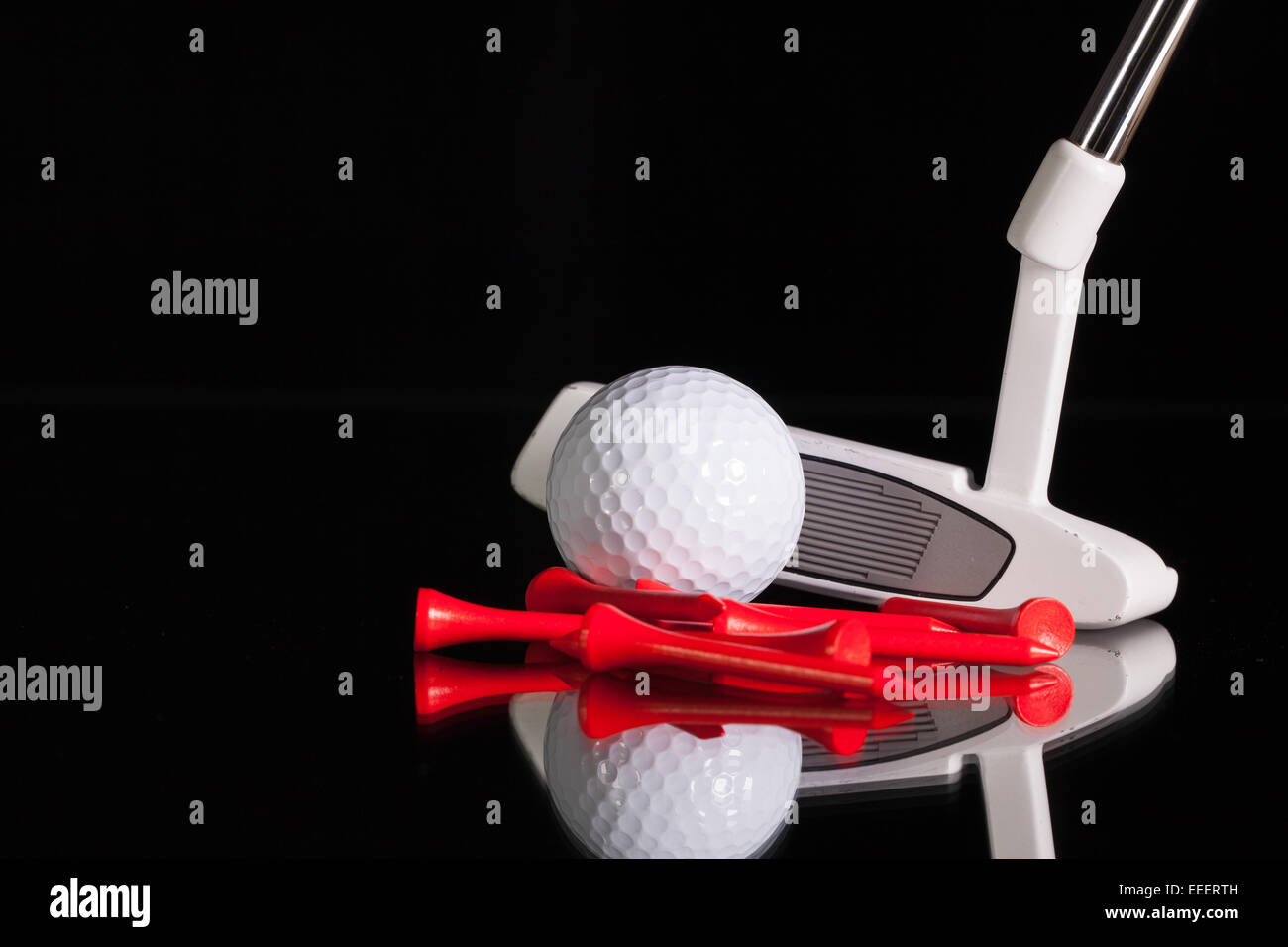 Golf putter and different golf equipments on the black glass desk Stock ...