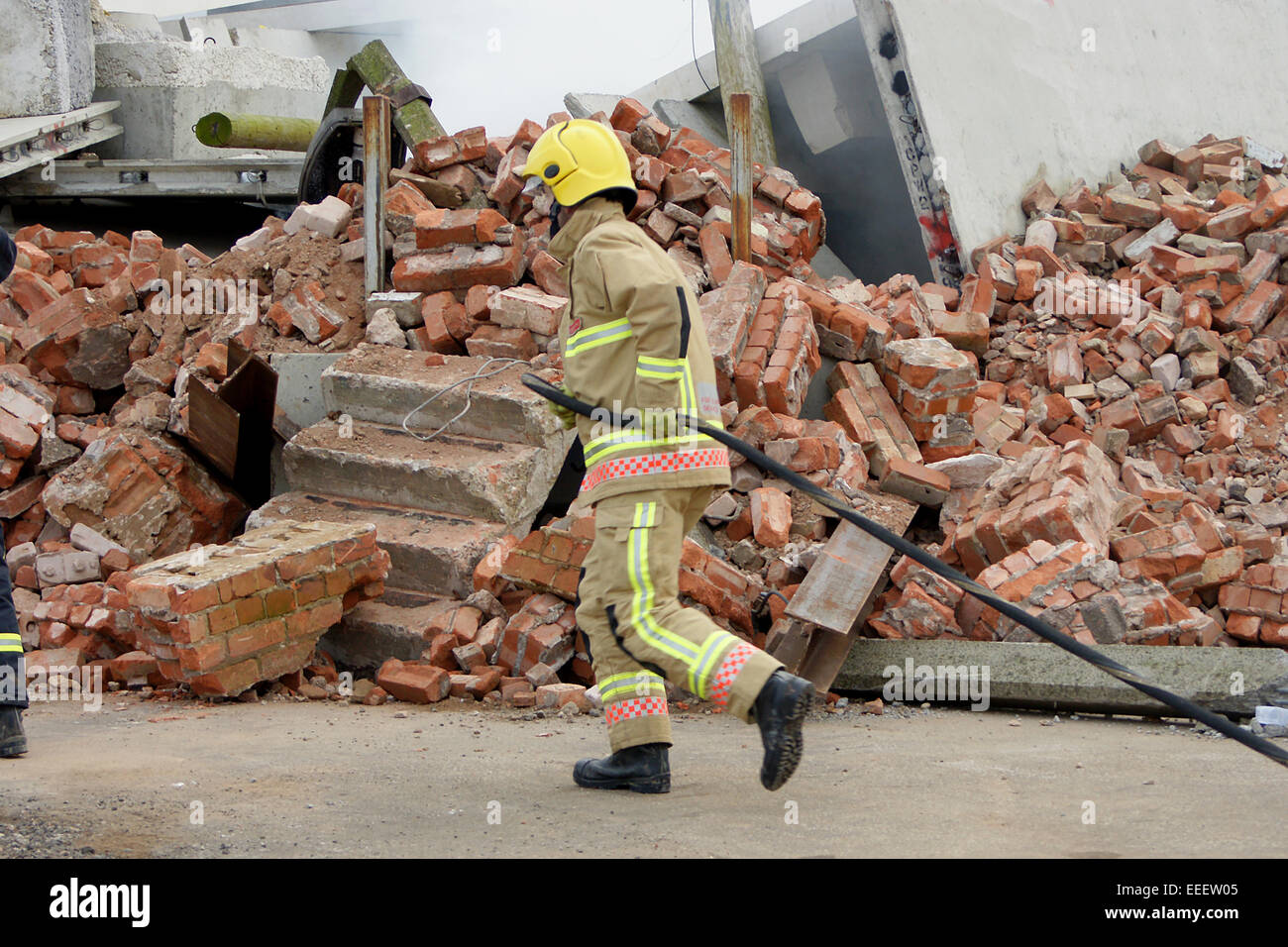 fire fighter at building collapse Stock Photo - Alamy