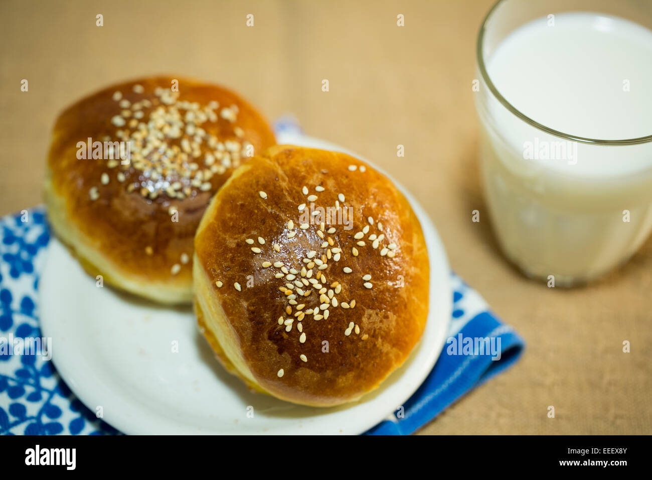 Small buns ready to eat and served with milk Stock Photo - Alamy