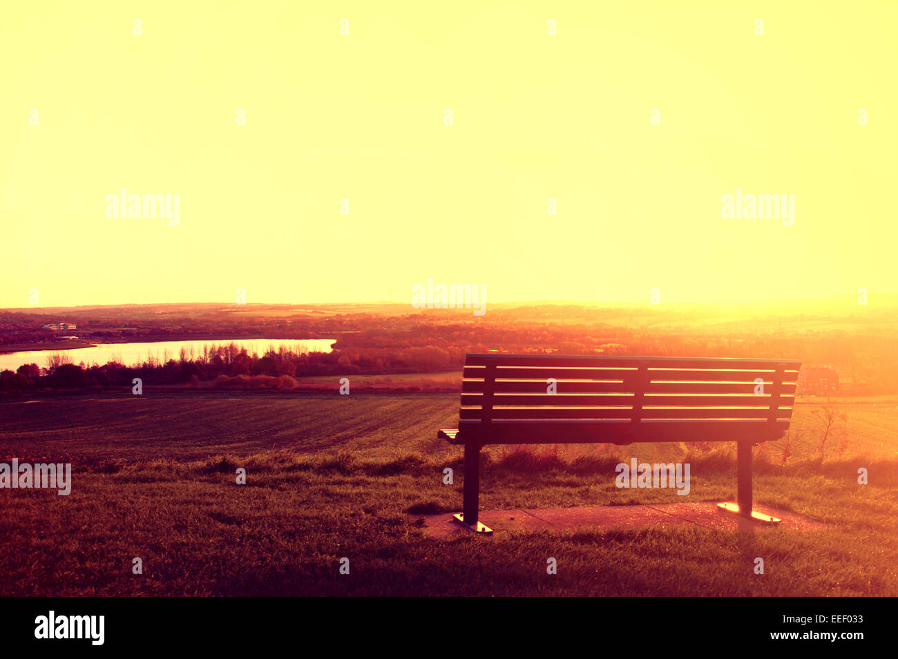 Landscape conceptual image. Alone bench at sunset Stock Photo - Alamy