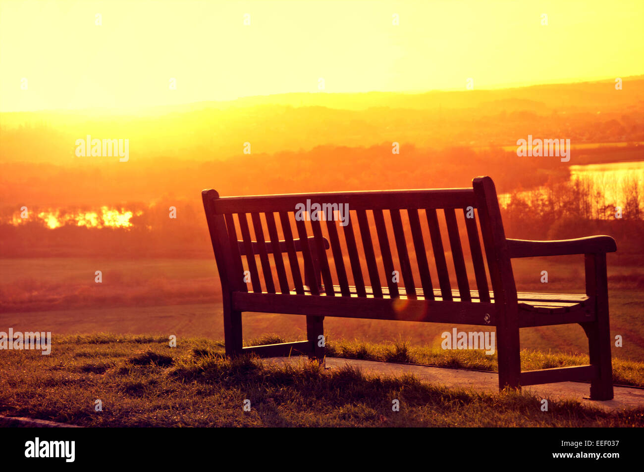 Landscape conceptual image. Alone bench at sunset Stock Photo - Alamy