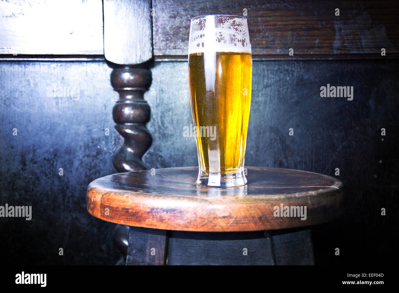 Alcohol conceptual image. Glass of fresh cold beer put on the bar chair ...