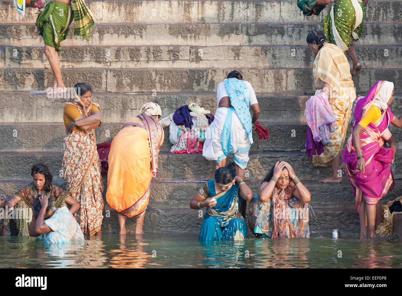 Varanasi, India. Hindu women bathing and praying in the Ganges river ...