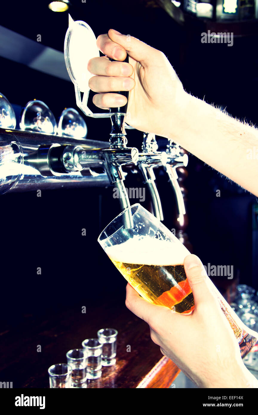 Bartender giving the beer from dispenser. Alcohol conceptual image ...