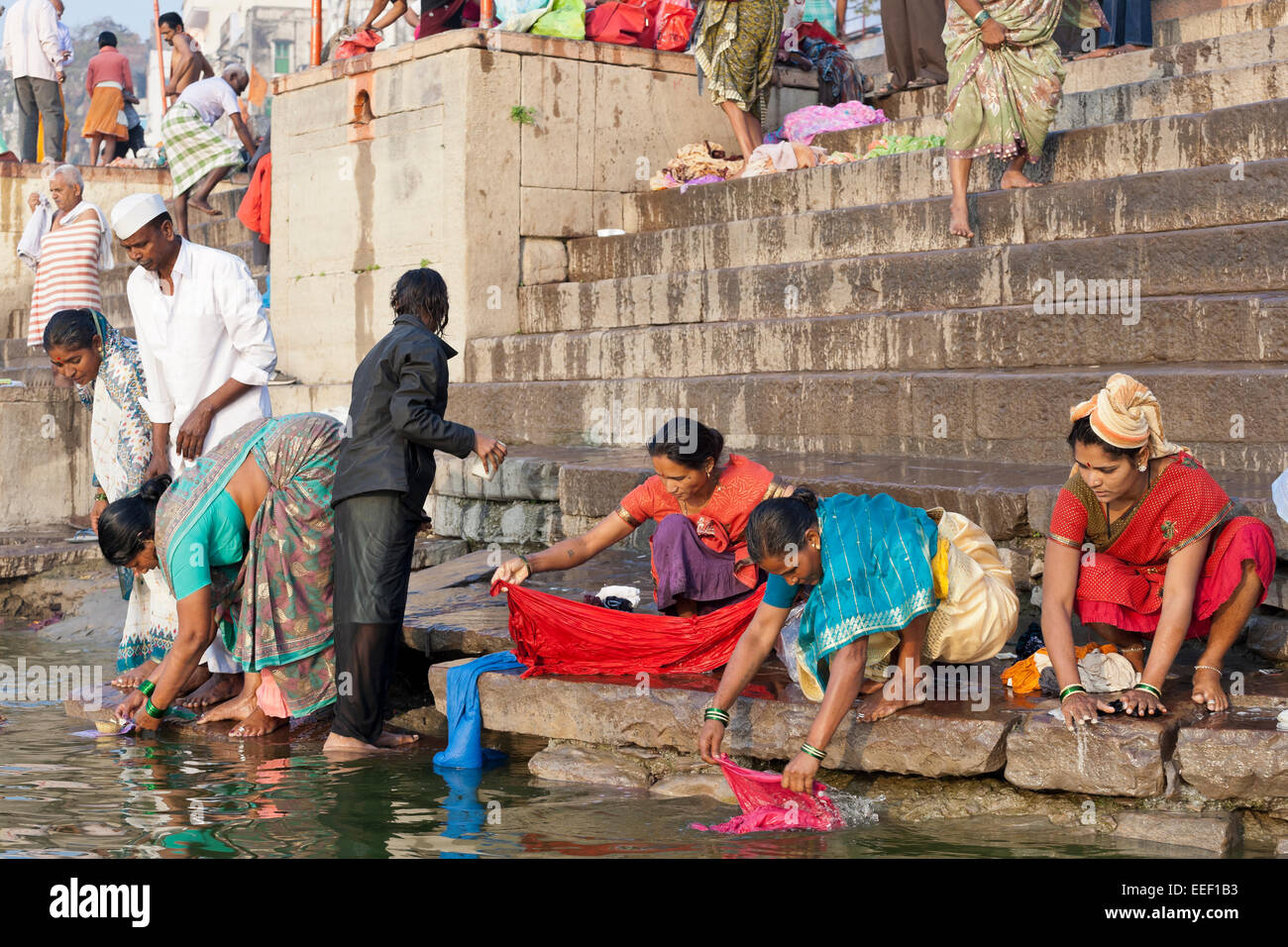 Varanasi, India. Hindus by the Ganges river, bathing, washing, praying ...