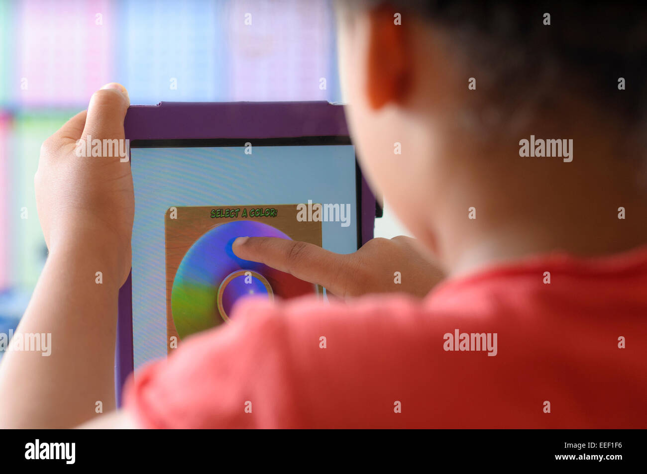 Child 7-8 Years Old Is Playing On An Ipad Stock Photo - Alamy