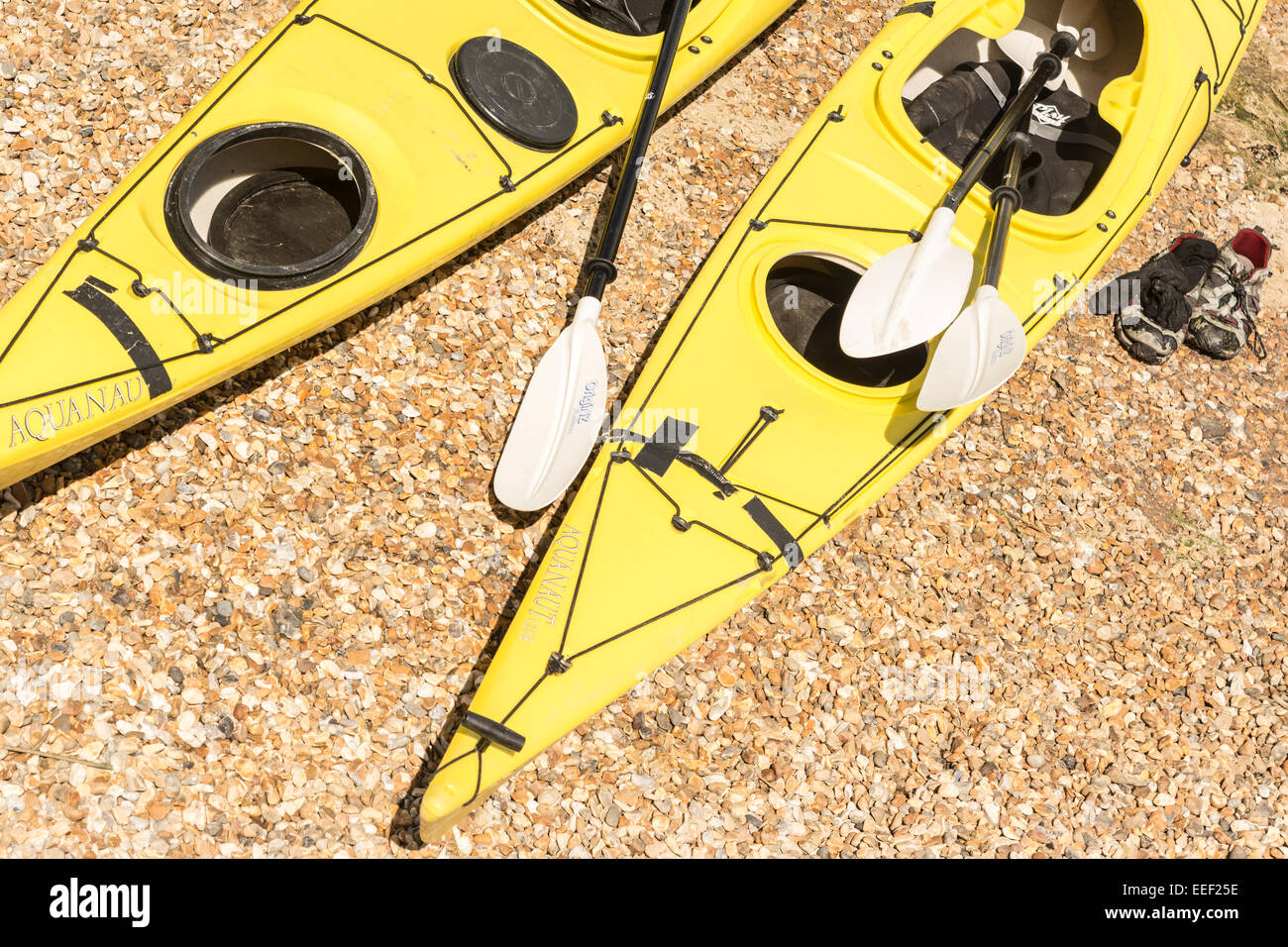 Kayaks left on a beach after use Stock Photo - Alamy
