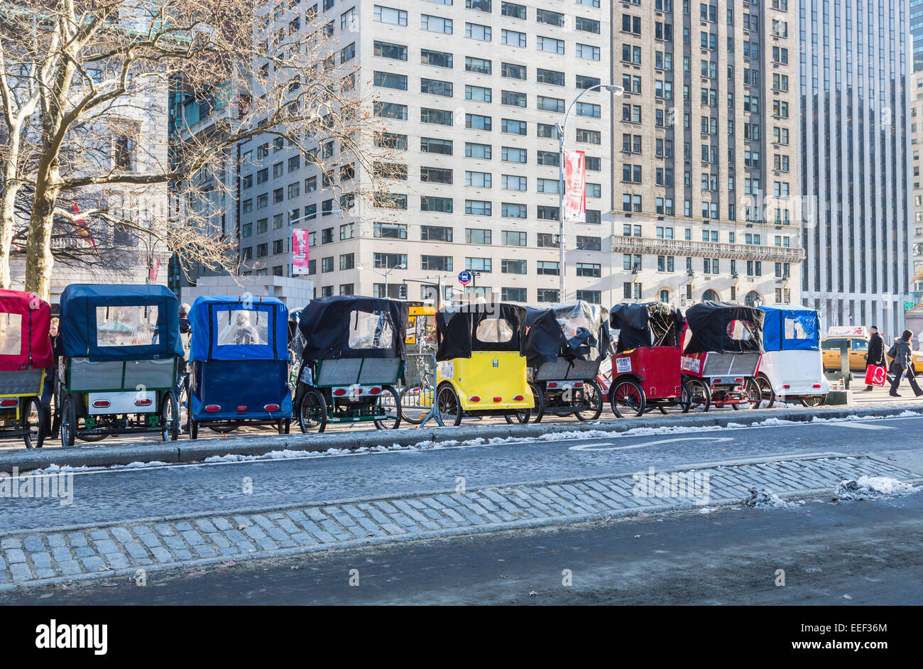 Line of colourful three-wheeled cycle taxis lined up in roadside ...