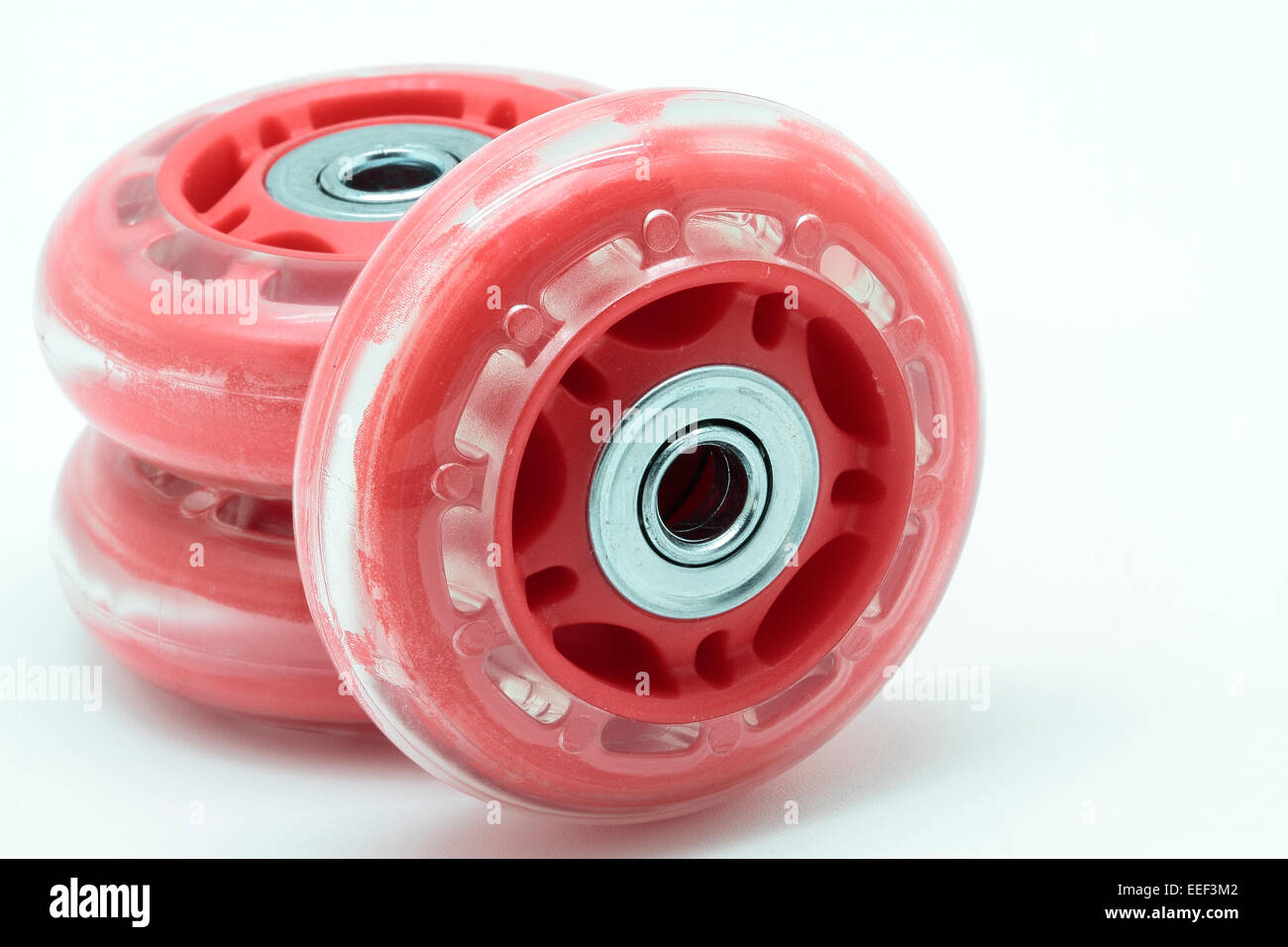 three red wheels skates stacked on white background Stock Photo - Alamy