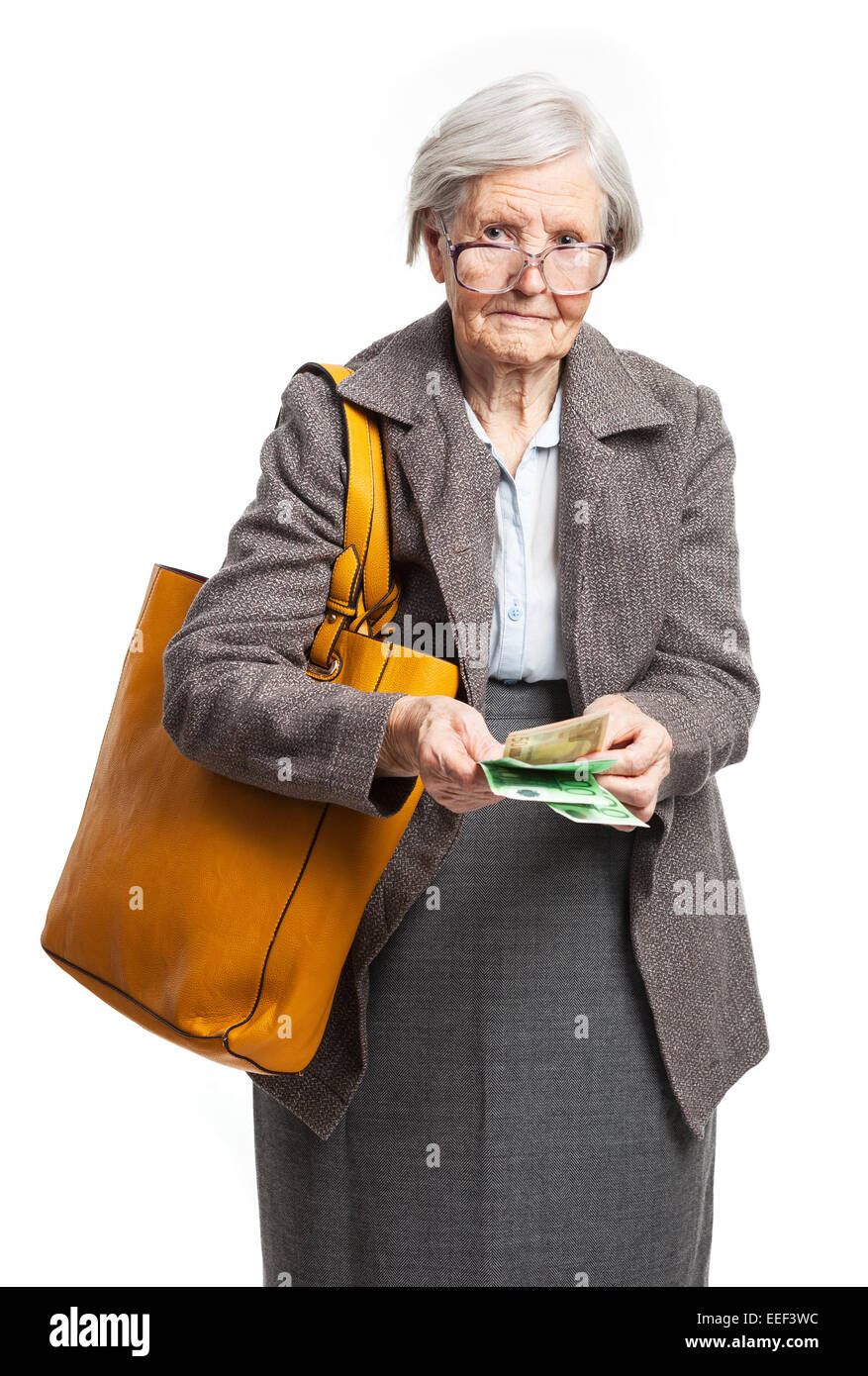 Senior woman counting money while standing over white background Stock ... Senior woman counting money while standing over white background Stock ...