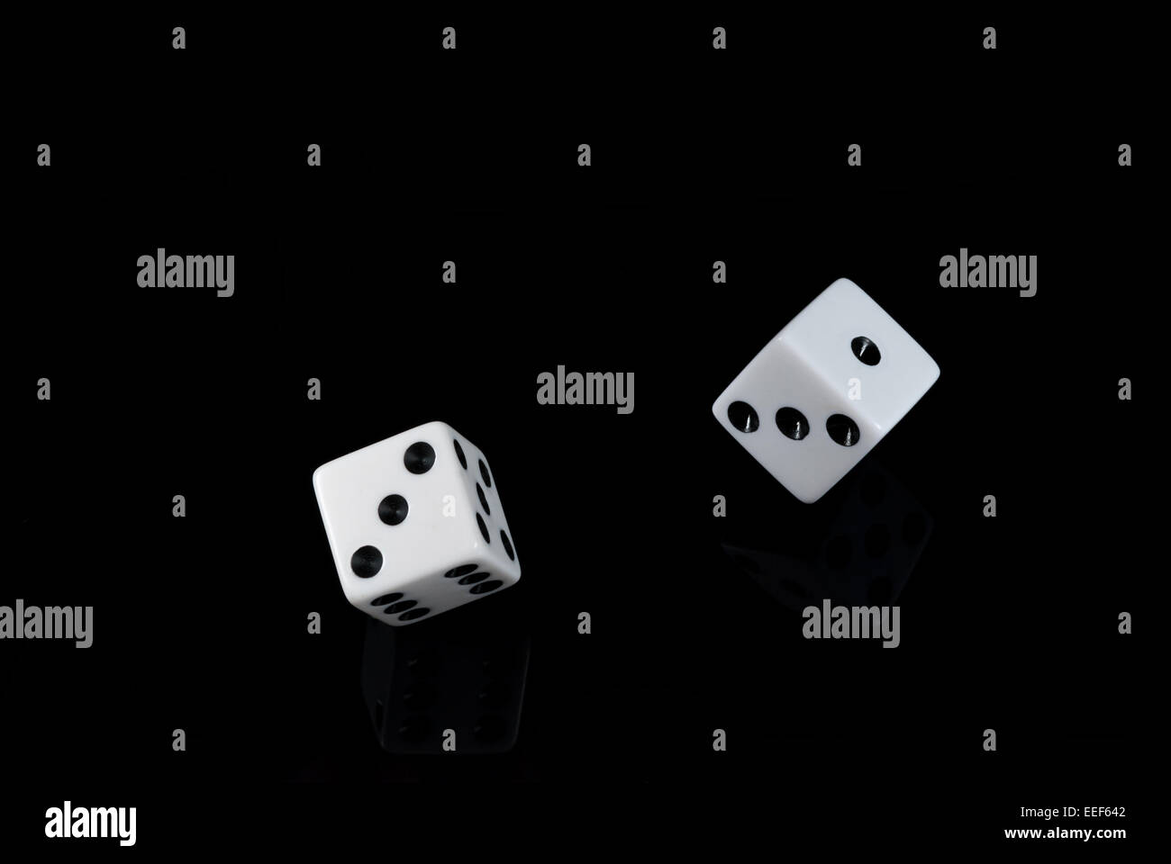 Two white dice on black reflect background Stock Photo - Alamy