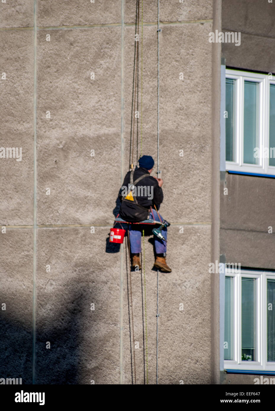 Man works at height from rope Stock Photo - Alamy