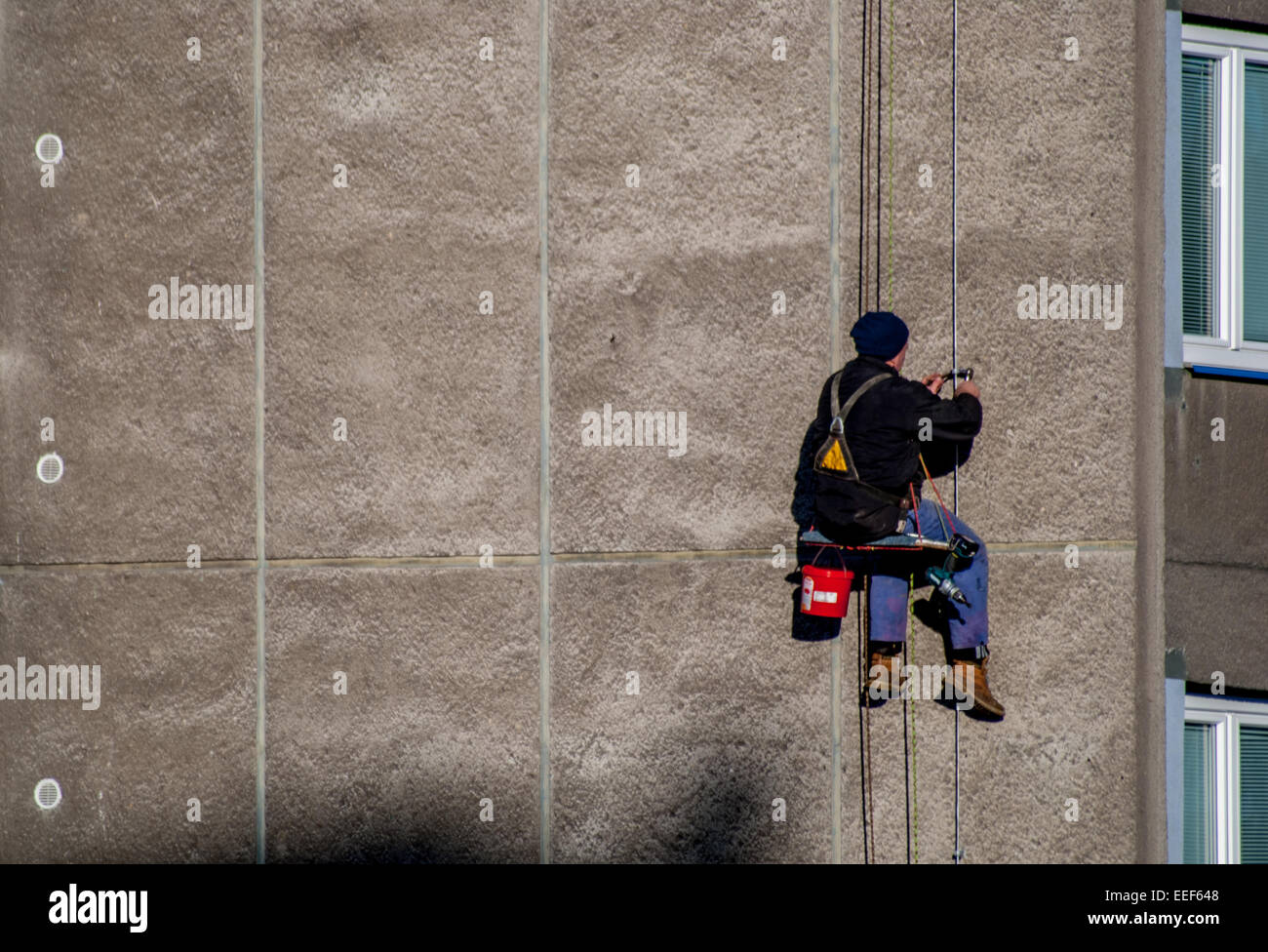 Man works at height from rope Stock Photo - Alamy