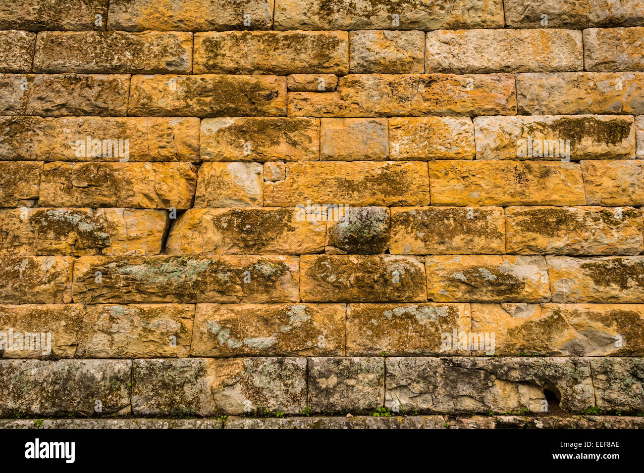 Wall made of large yellow stones Stock Photo - Alamy