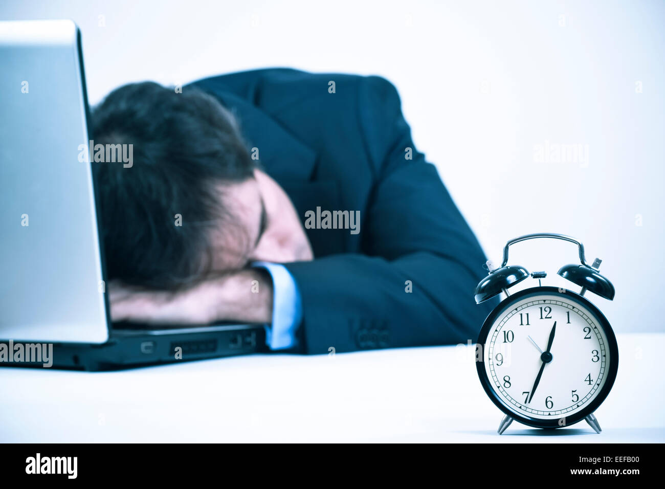 Businessman sleeping on computer Stock Photo - Alamy