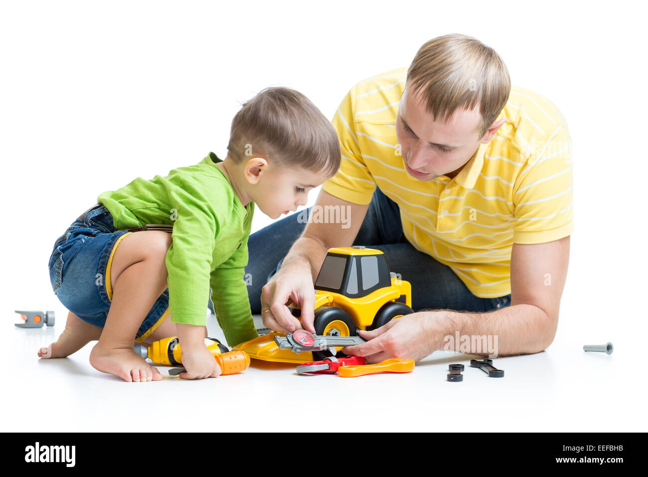 kid and his dad repair toy tractor Stock Photo - Alamy