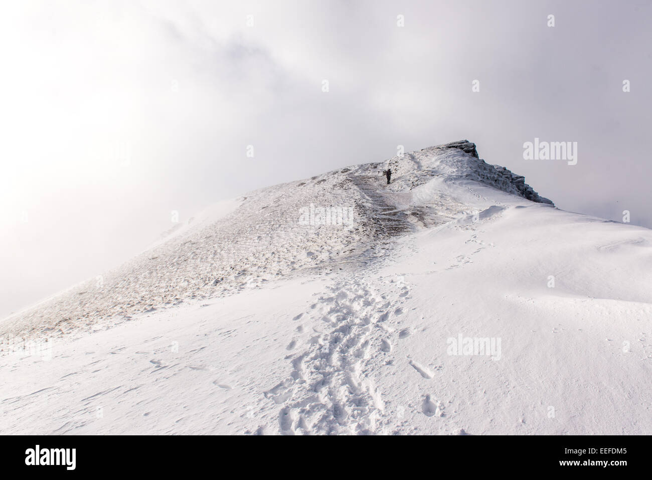 A walker on the side of Corn Du in the Brecon Beacons, the neighbouring ...