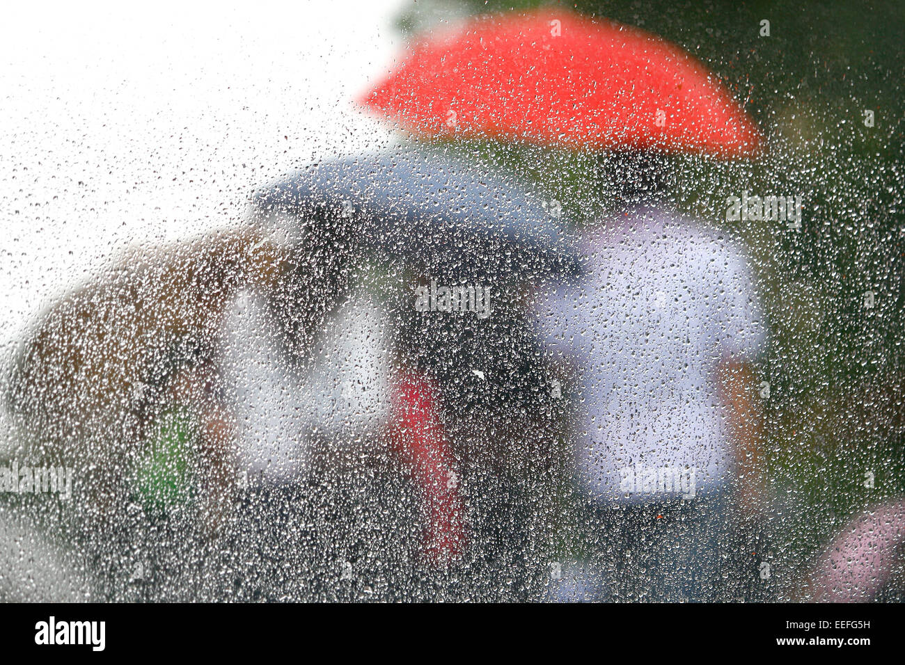 Rain on a window looking out to people in a street scene Stock Photo ...