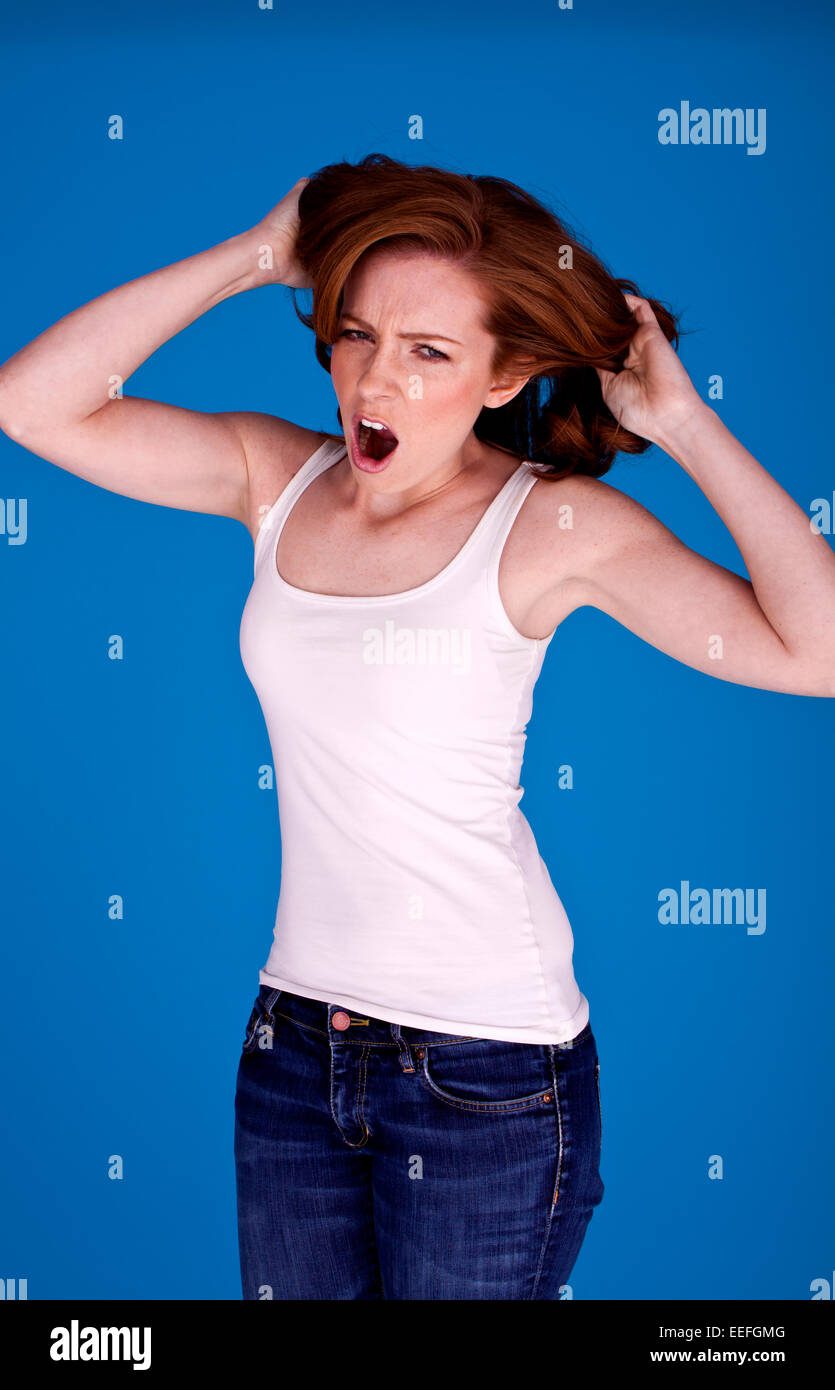 Young attractive woman making her emotions clear that she is angry ...