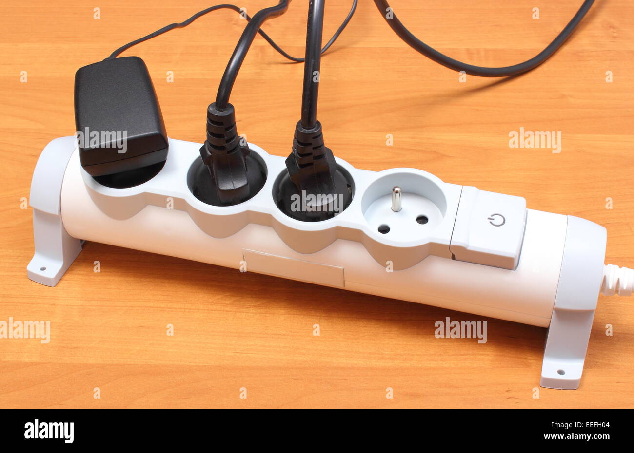 Electrical plugs with cords connected to electrical power strip ...