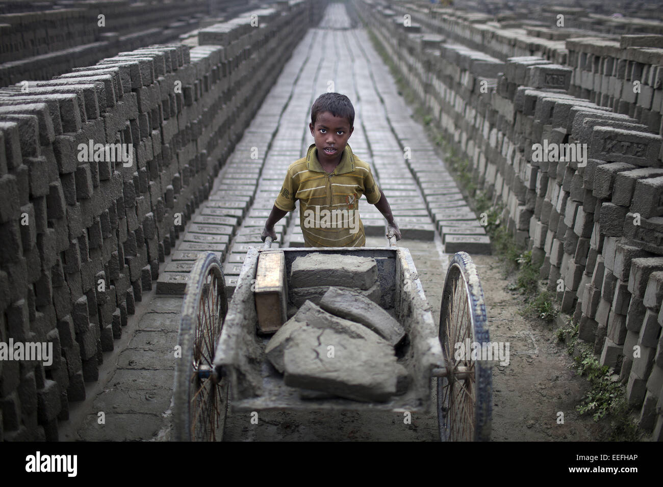 A child labour works in a brick factory in Dhaka on 17 January 2015 ...