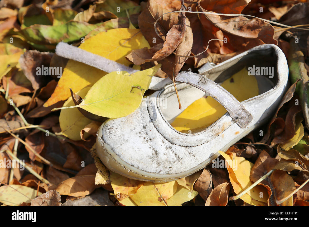 Lost Female Children White Shoes in park Stock Photo - Alamy