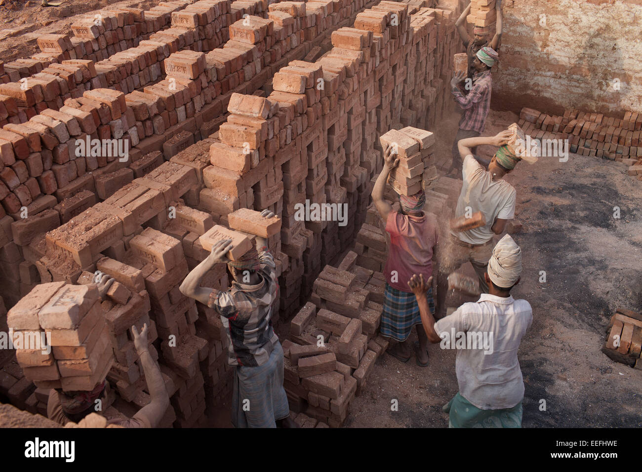Bangladeshi day labourers work in a brick factory in Dhaka on 17 ...