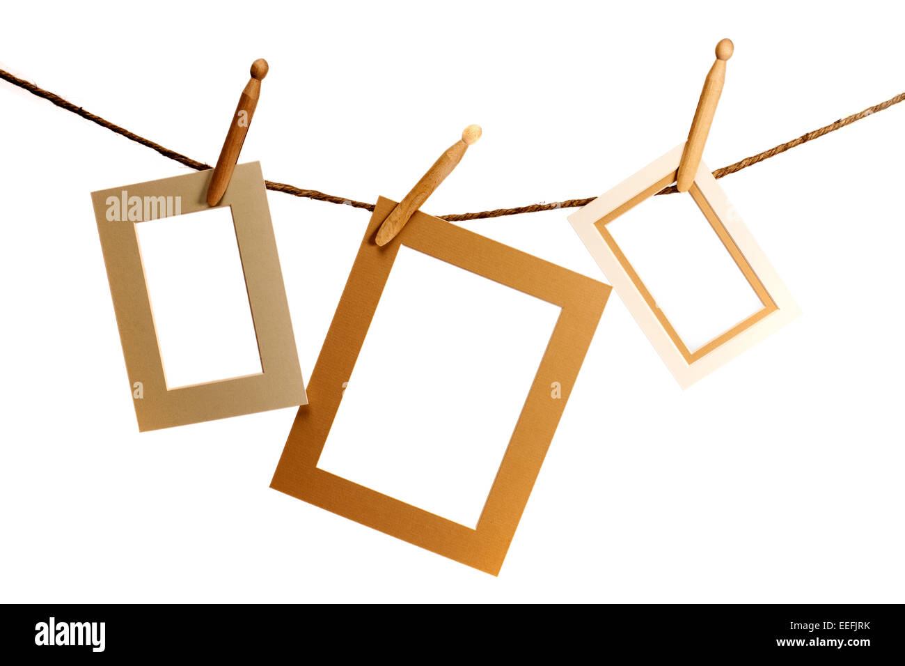 Three frames hanging from a rope over a white background Stock Photo ...