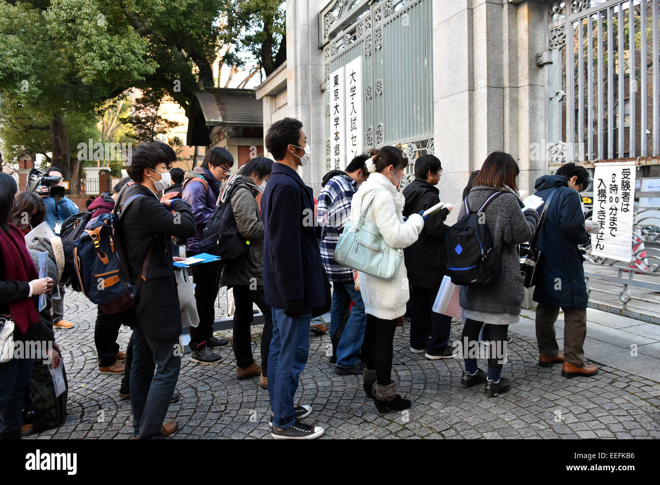 Tokyo, Japan. 17th Jan, 2015. Text-takers wait patiently in line for ...